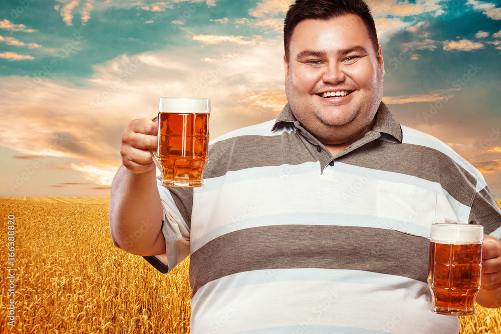 Young fat man at oktoberfest, drinking beer on yellow background. Stock ...
