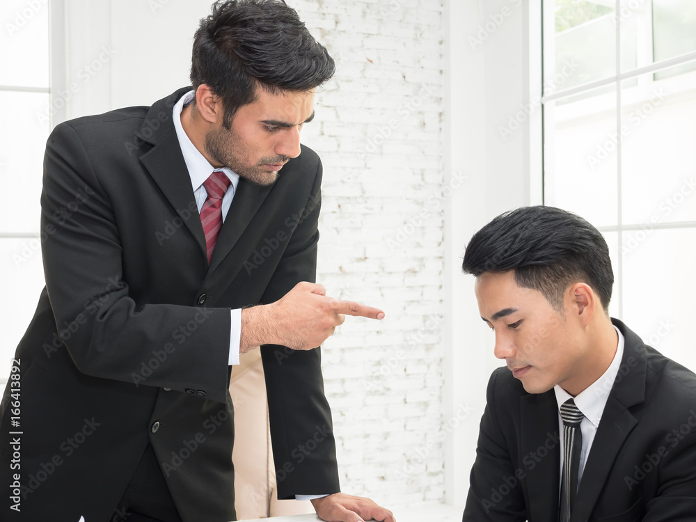 Boss pointing finger to the team member upset on target sales failure ...