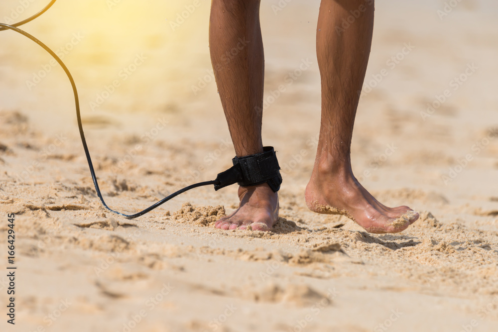 Asian young surfer with leg rope walking on the beach..Sunny day and ...