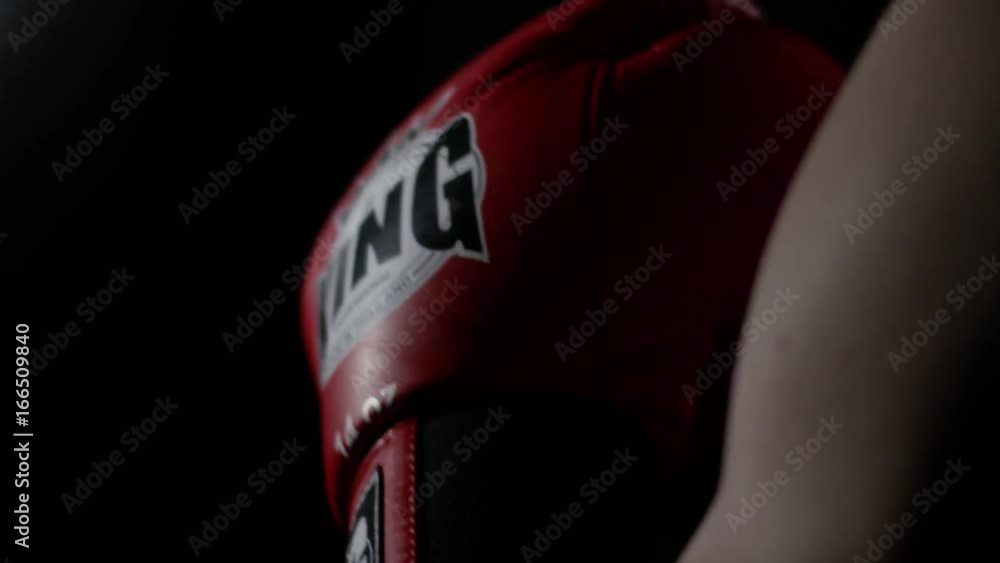 Muscular handsome fighter giving a forceful forward kick during a ...