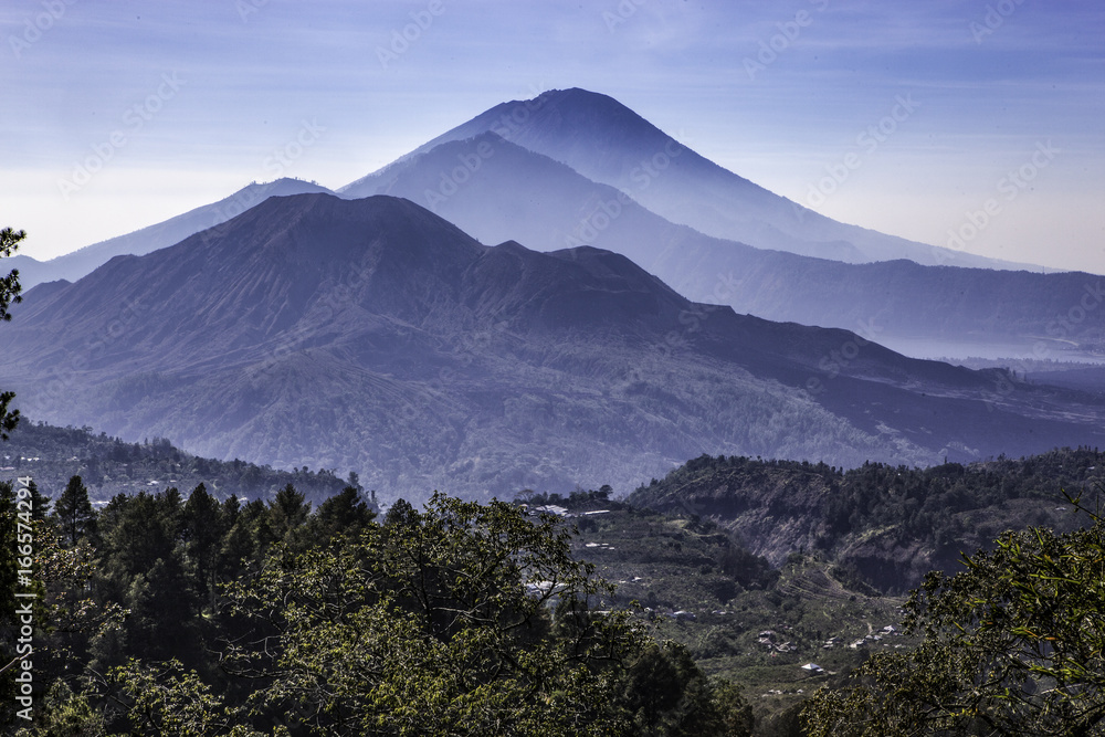 Gunung Batur volcano mountain in blue light with forest in front, Bali ...
