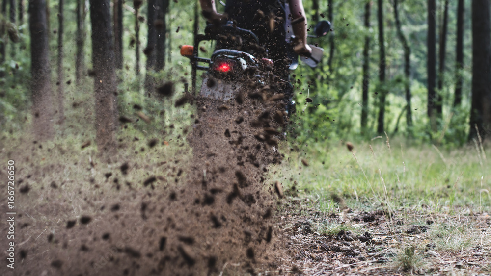 Dirt flies at the camera from a sharp start. Stock Photo | Adobe Stock