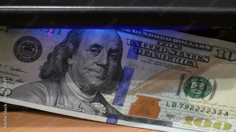 One hundred dollar bill is highlighted in blue light. Full HD 1920x1080 ...