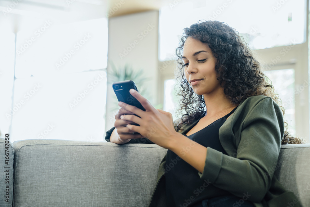 Woman texting on cell phone Stock Photo | Adobe Stock