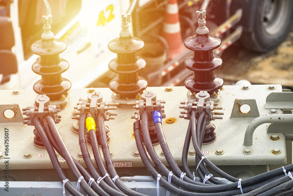 High voltage electric transformer in a power substation above the ...