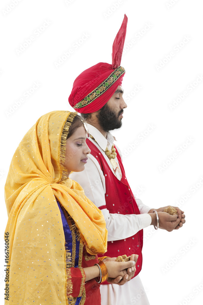 Sikh couple praying Stock Photo | Adobe Stock