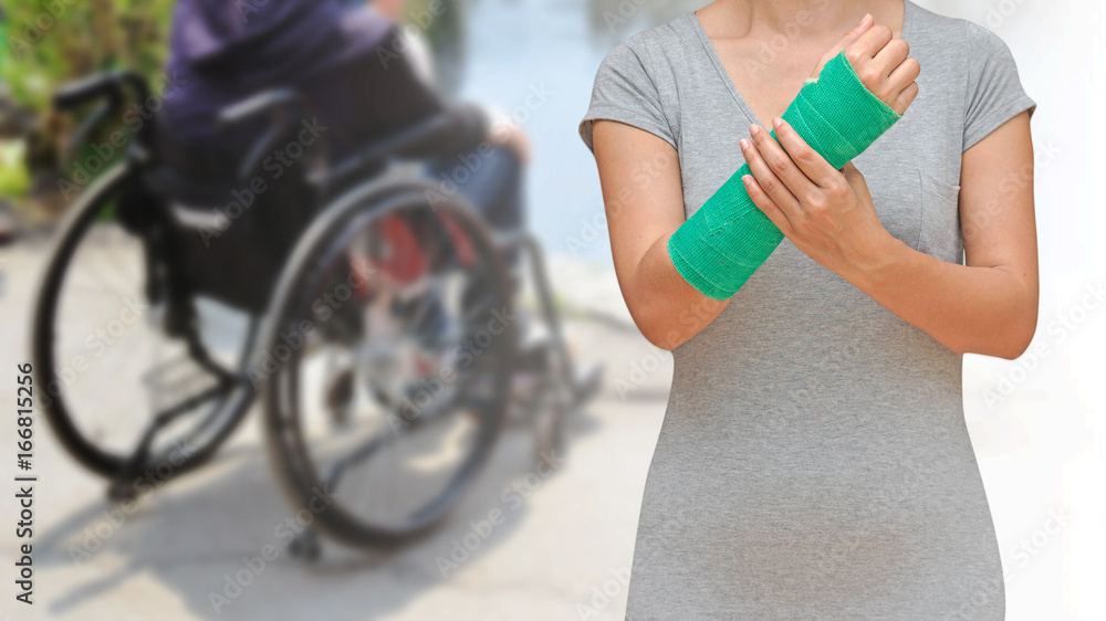 Injury woman wearing sportsware with green cast on arm on blurred ...