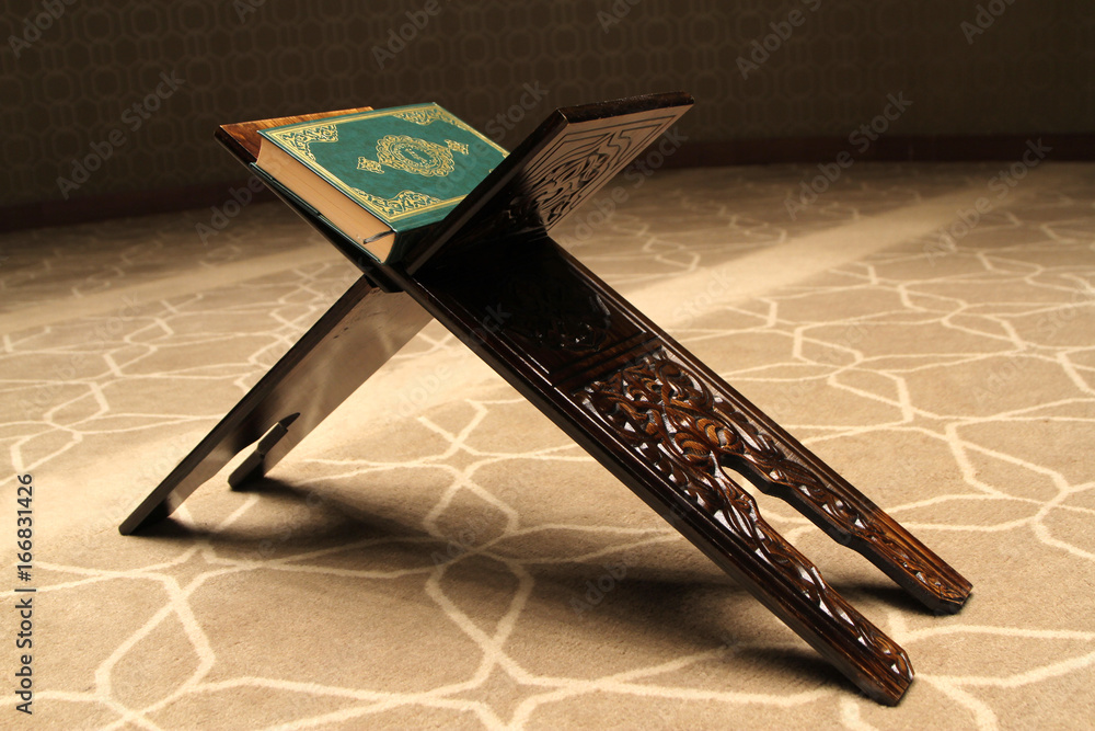 Quran on a wooden stand in mosque. Quran is holy book religion of Islam ...