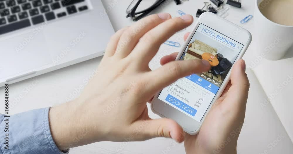 Man booking hotel suit using his smartphone and online booking mobile ...