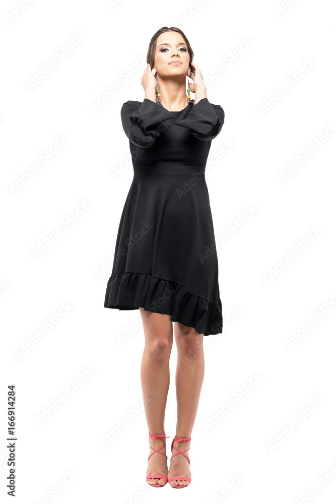 Vogue glamour woman in black dress touching hair with head tilted back ...