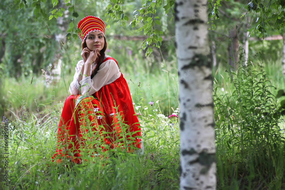 Slav in traditional dress is sitting in nature Stock Photo | Adobe Stock