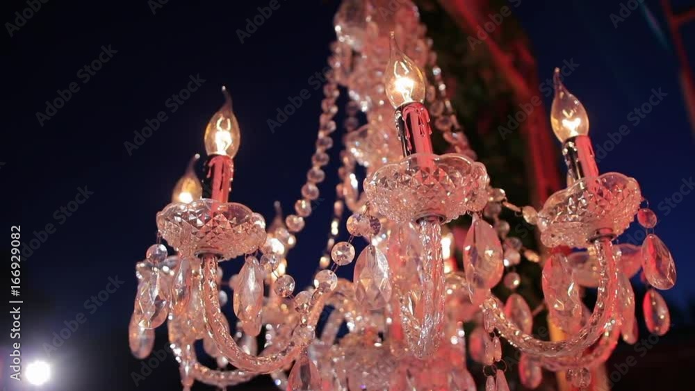 Candle-like, glass crystal, chandelier ceiling lights on the metal ...