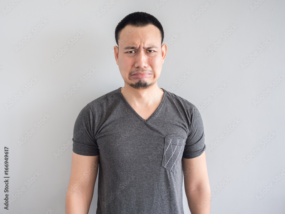 Sad and scared asian man in black t-shirt. Stock Photo | Adobe Stock