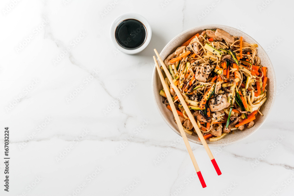 Traditional Asian food. Lunch stirfry: rice noodles, zucchini, carrots ...