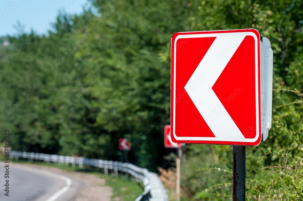 Sign of the left turn. Road signs warn of a sharp turn left. Stock ...