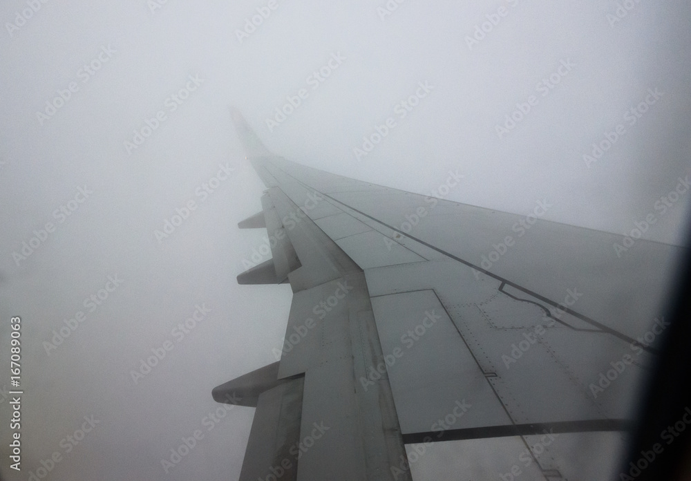 Looking trough window of an aircraft plane wing in fog. Stock Photo ...