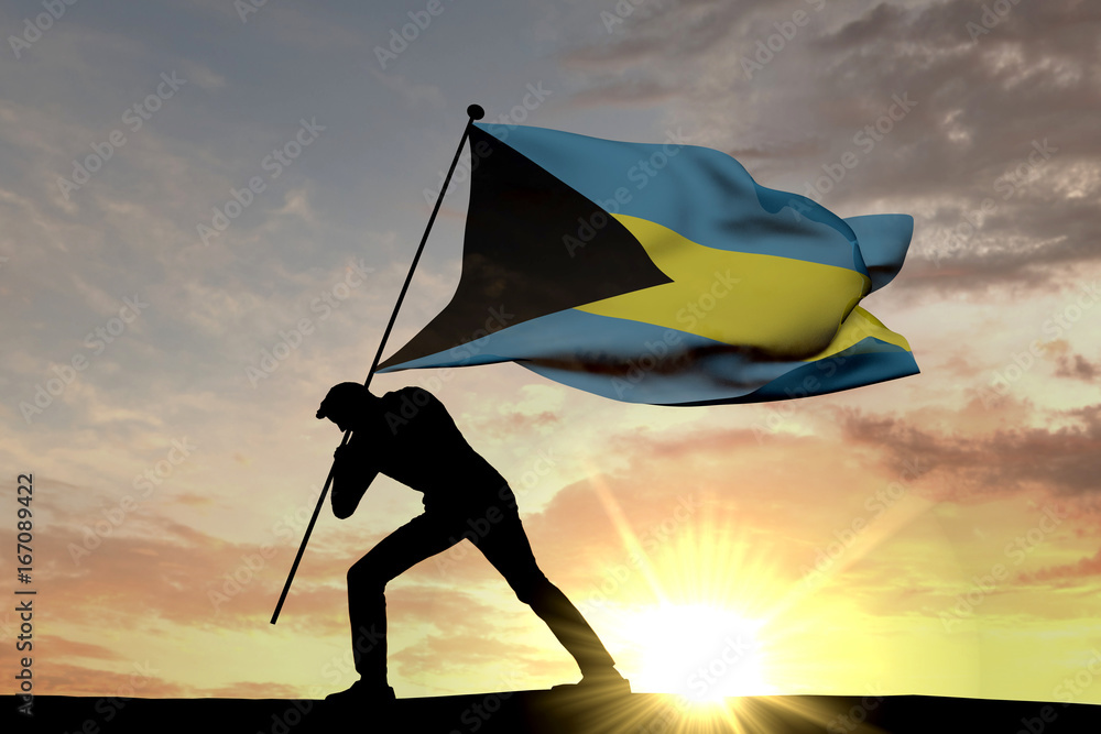 Bahamas flag being pushed into the ground by a male silhouette. 3D ...