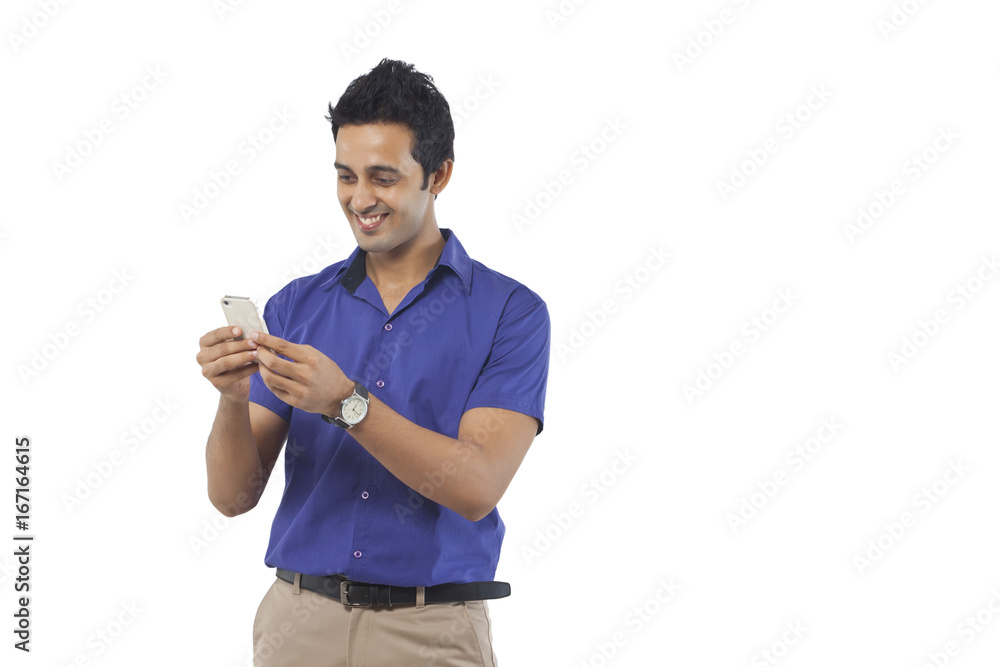 Young man reading an sms on a mobile phone Stock Photo | Adobe Stock
