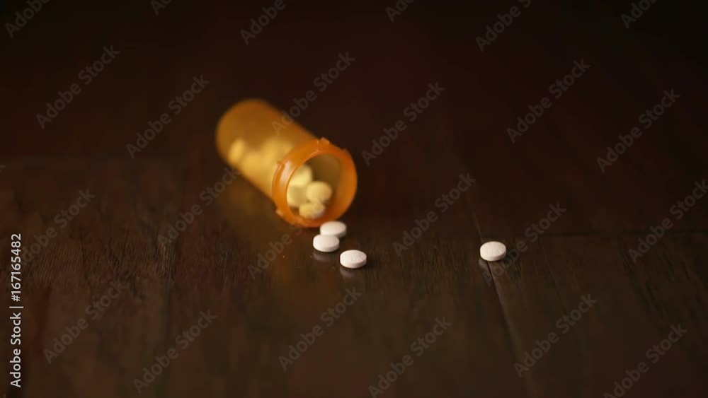Orange Pill Bottle Falls and Some Pills Fall Out. a prescription orange ...