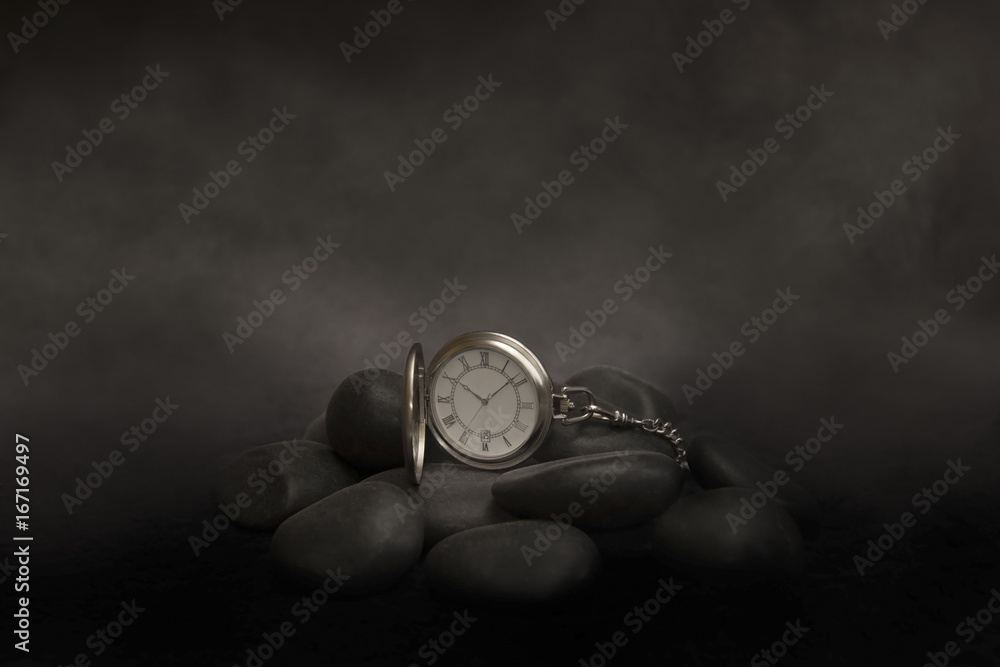 Silver Pocket Watch on Top of Black Rocks Stock Photo | Adobe Stock