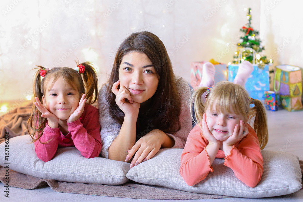 Cute female and two little girls children, posing for camera and Stock ...
