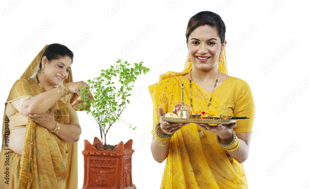 Mother and daughter making an offering Stock Photo | Adobe Stock