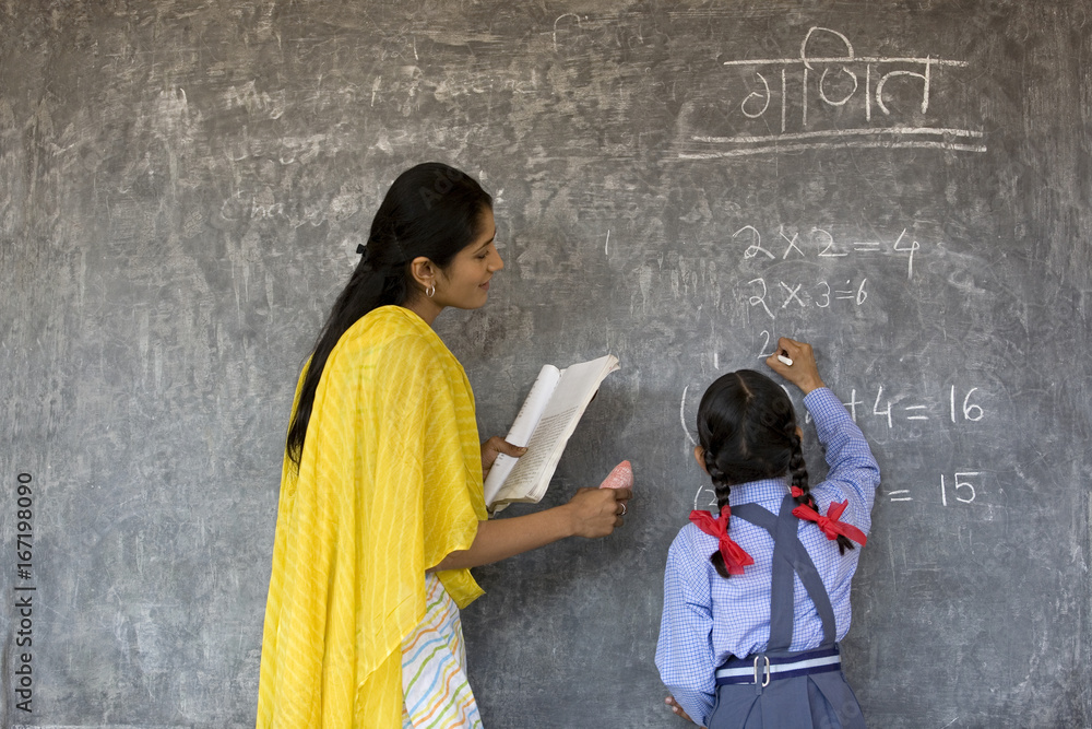 Young girl writing on the board Stock Photo | Adobe Stock
