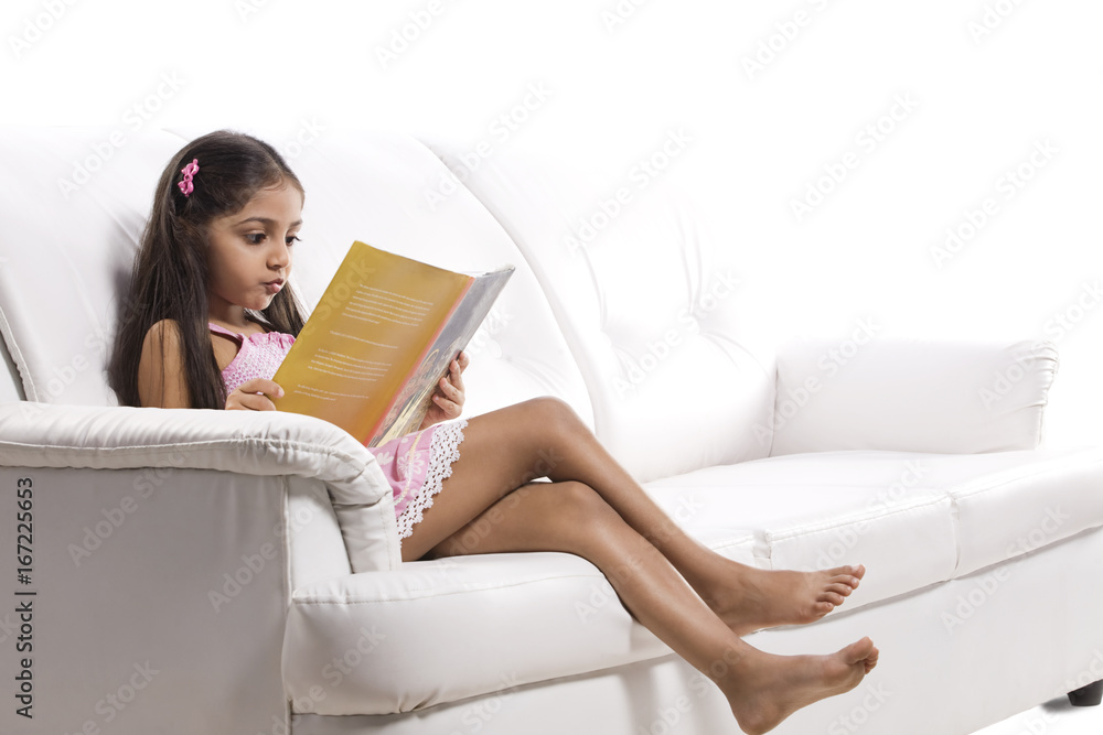 Little girl reading a story book Stock Photo | Adobe Stock