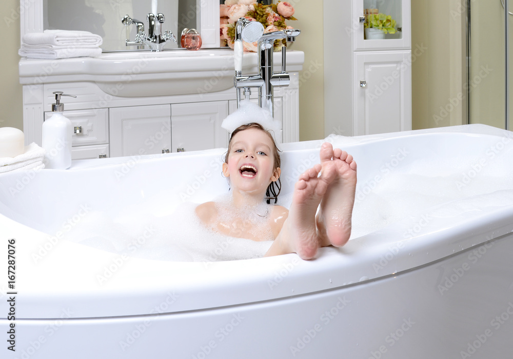 Happy little baby girl face swimming in the bathroom. Portrait of baby ...