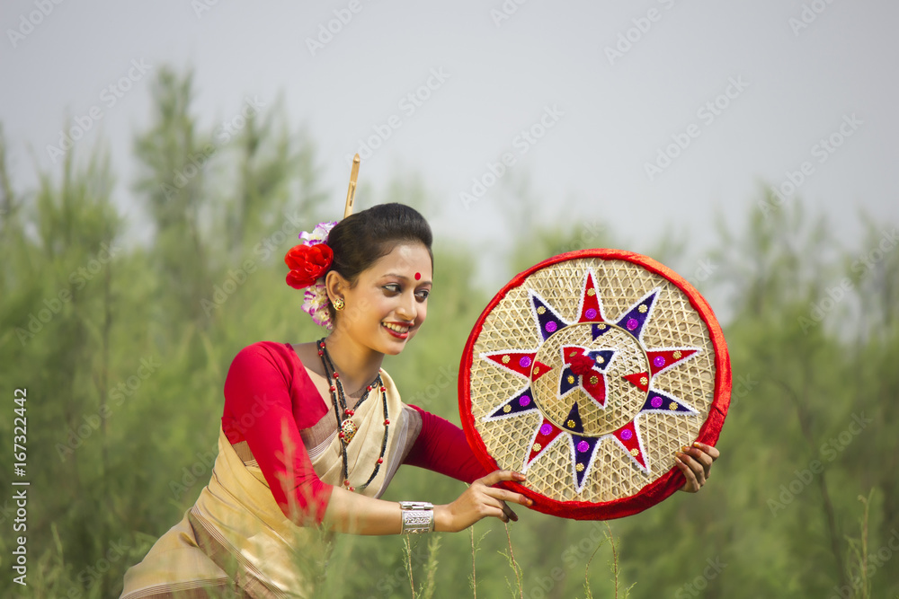 Bihu dancer holding a jaapi Stock Photo | Adobe Stock
