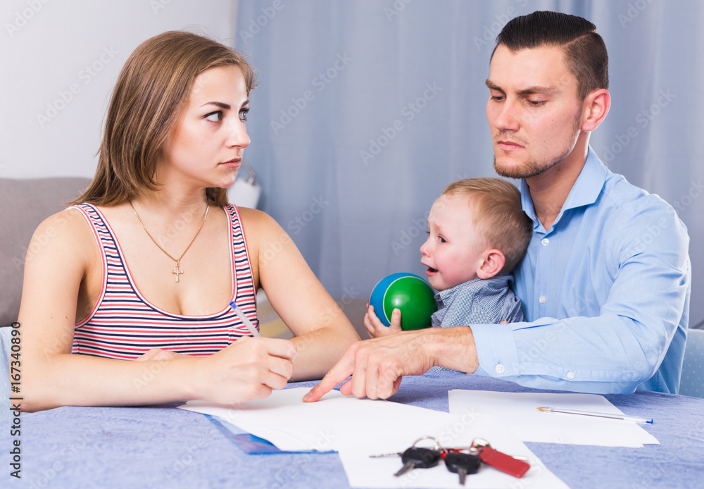 Sad woman with crying boy signing documents Stock Photo | Adobe Stock