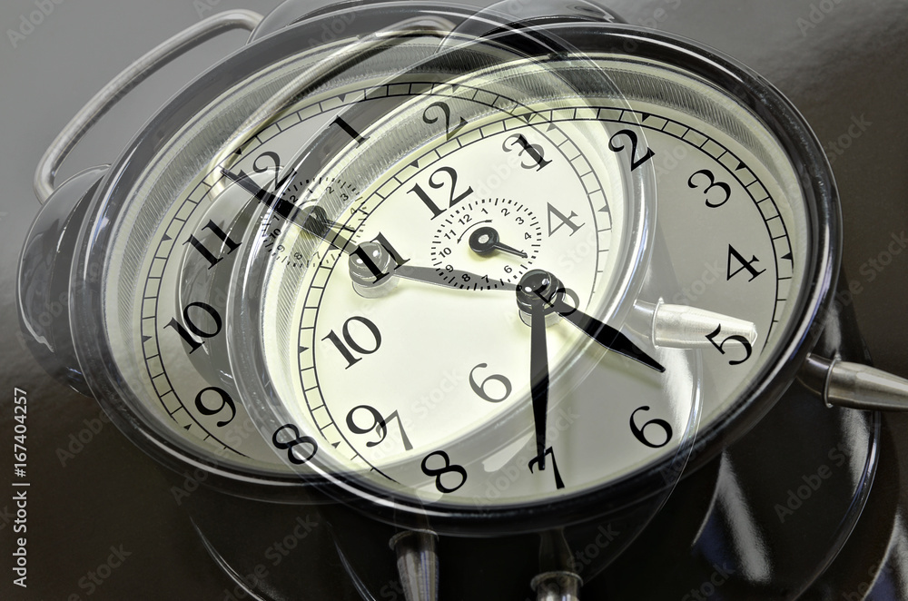 Overrunning Time / close up of two, overlapping images with retro alarm ...