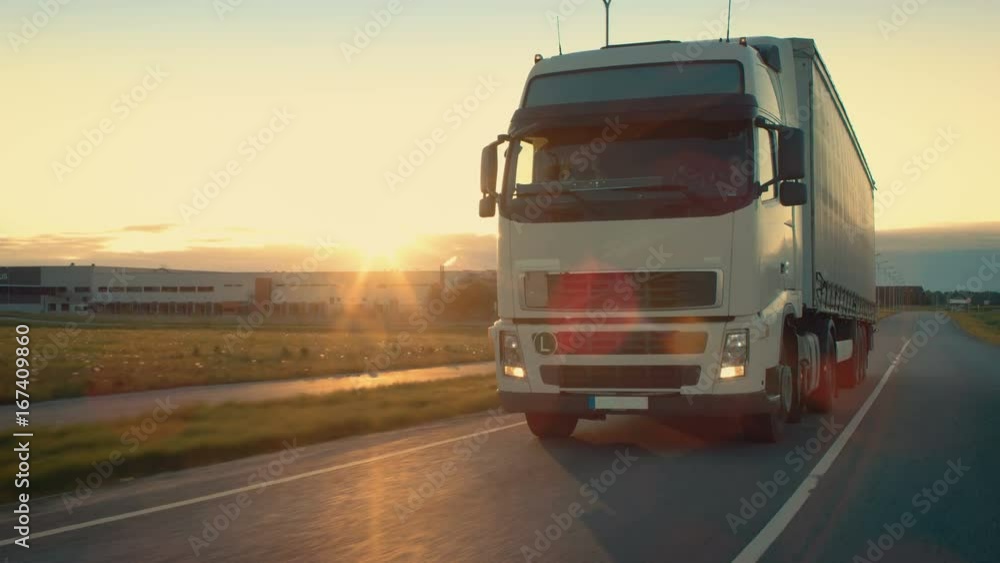 Front-View Camera Follows Semi-Truck with Cargo Trailer Driving on a ...