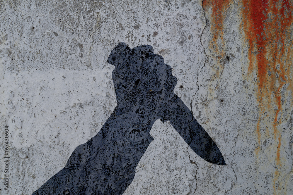 Silhouette of human hand with killing knife on bloody wall background ...