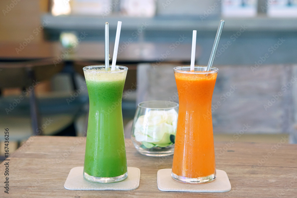 Closeup glass of cold pressed juice on wooden table, Fresh mixed fruits ...