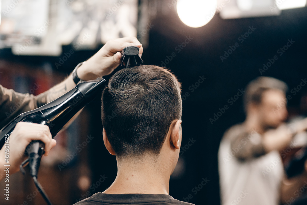 Male hippy customer in barber shop hairdresser on fashionable haircut ...