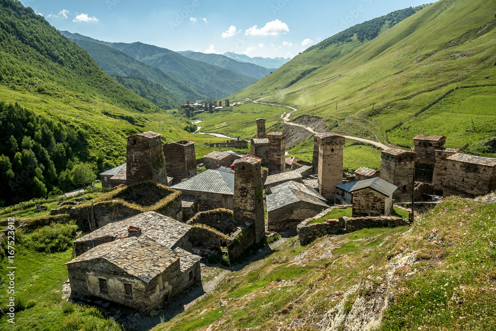 Scenery with old traditional stone towers and houses in rural village ...