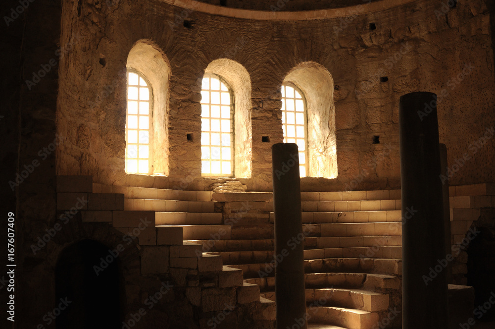 The rays of sunlight penetrate inside the ancient temple through the ...
