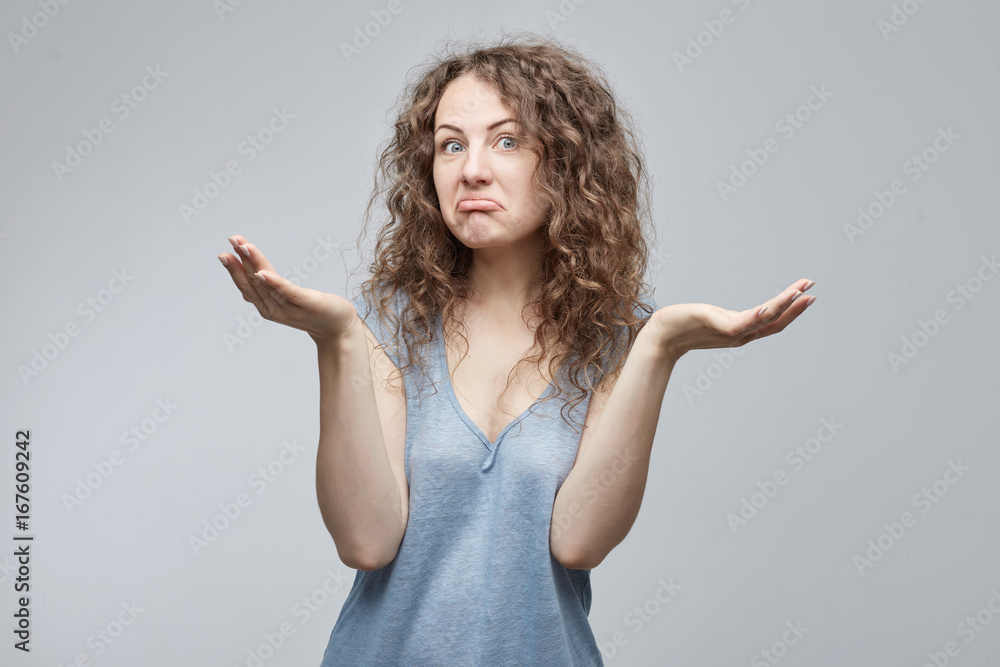Clueless and puzzled young Caucasian teenage female with wide opened ...