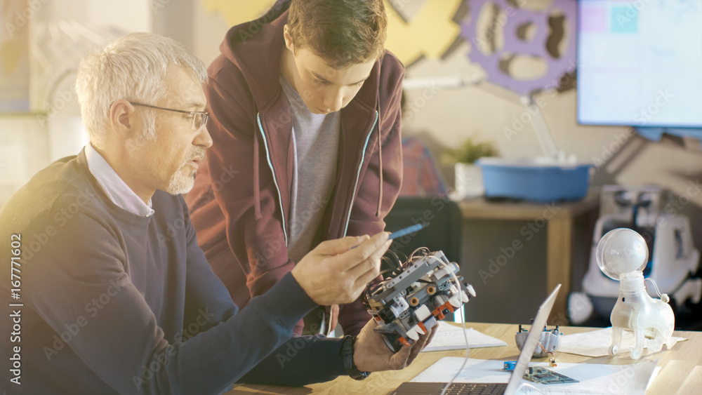 In Computer Science Class Teacher Examines programed Robot Engineered ...