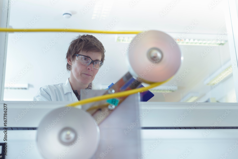 Scientist using cable bending test equipment to test electrical cable ...