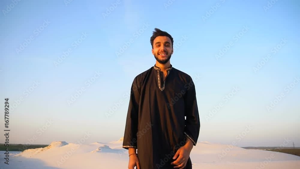 Portrait of happy Arab guy who poses and smiles looking at camera and ...