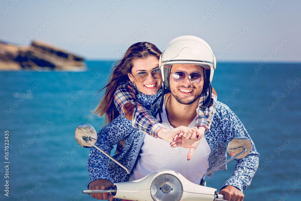 Beautiful young couple in love enjoying and having fun riding on a ...