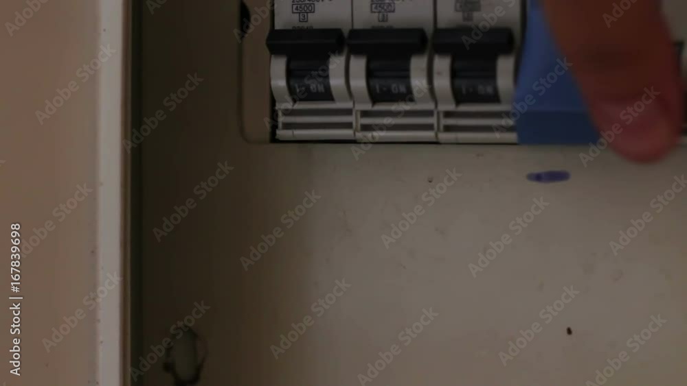 Female hand toggle switch in the switch box, All switches being turned ...