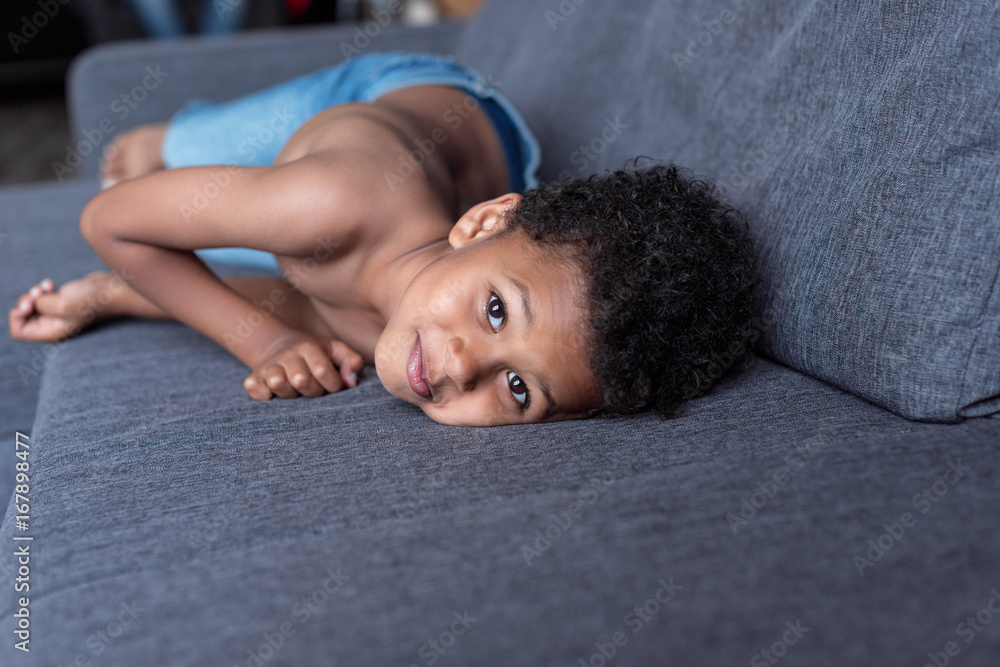 shirtless little kid playing on sofa Stock Photo | Adobe Stock