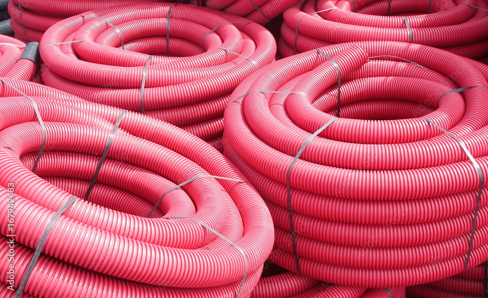 Red corrugated plastic pipes used for underground electrical lines ...