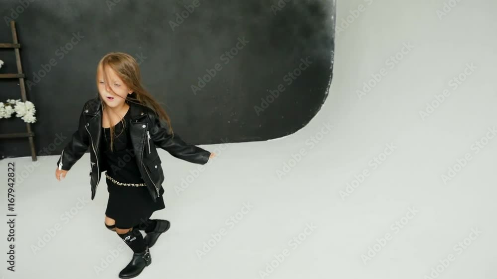 little girl in rocker style throws hat over white background Stock ...