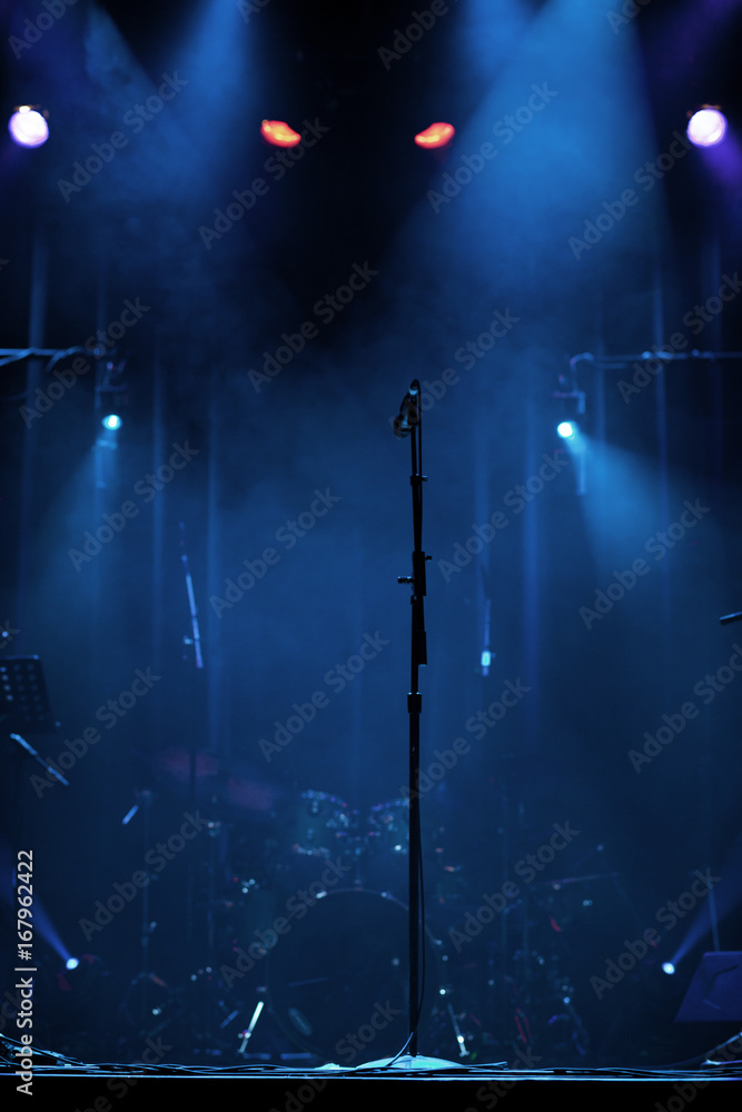 Microphone on stage with creepy lights behind Stock Photo | Adobe Stock