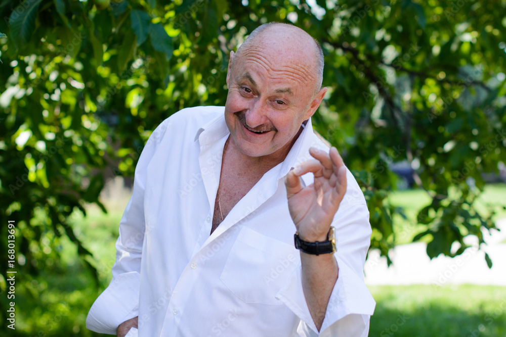 Successful excited elderly man in white shirt showing ok sign while ...