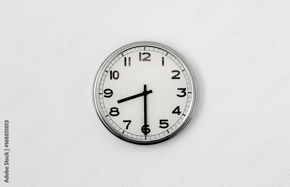 White Clock hanging on a white wall showing time 8:30 Stock Photo ...